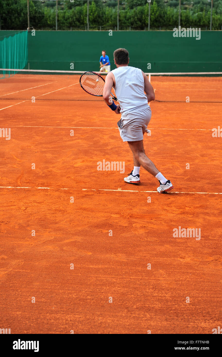 One man play tennis on outdoor court Stock Photo - Alamy