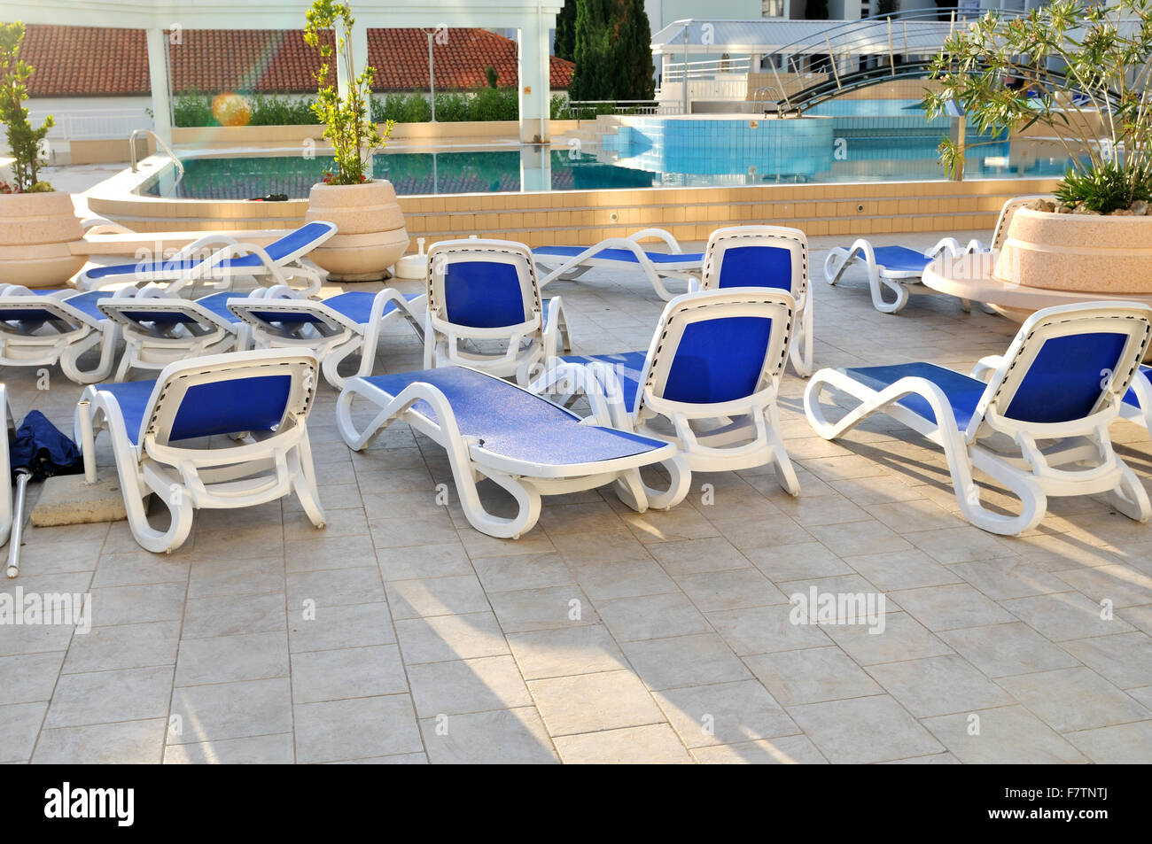 Empty chairs by the pool of luxery hotel Stock Photo - Alamy