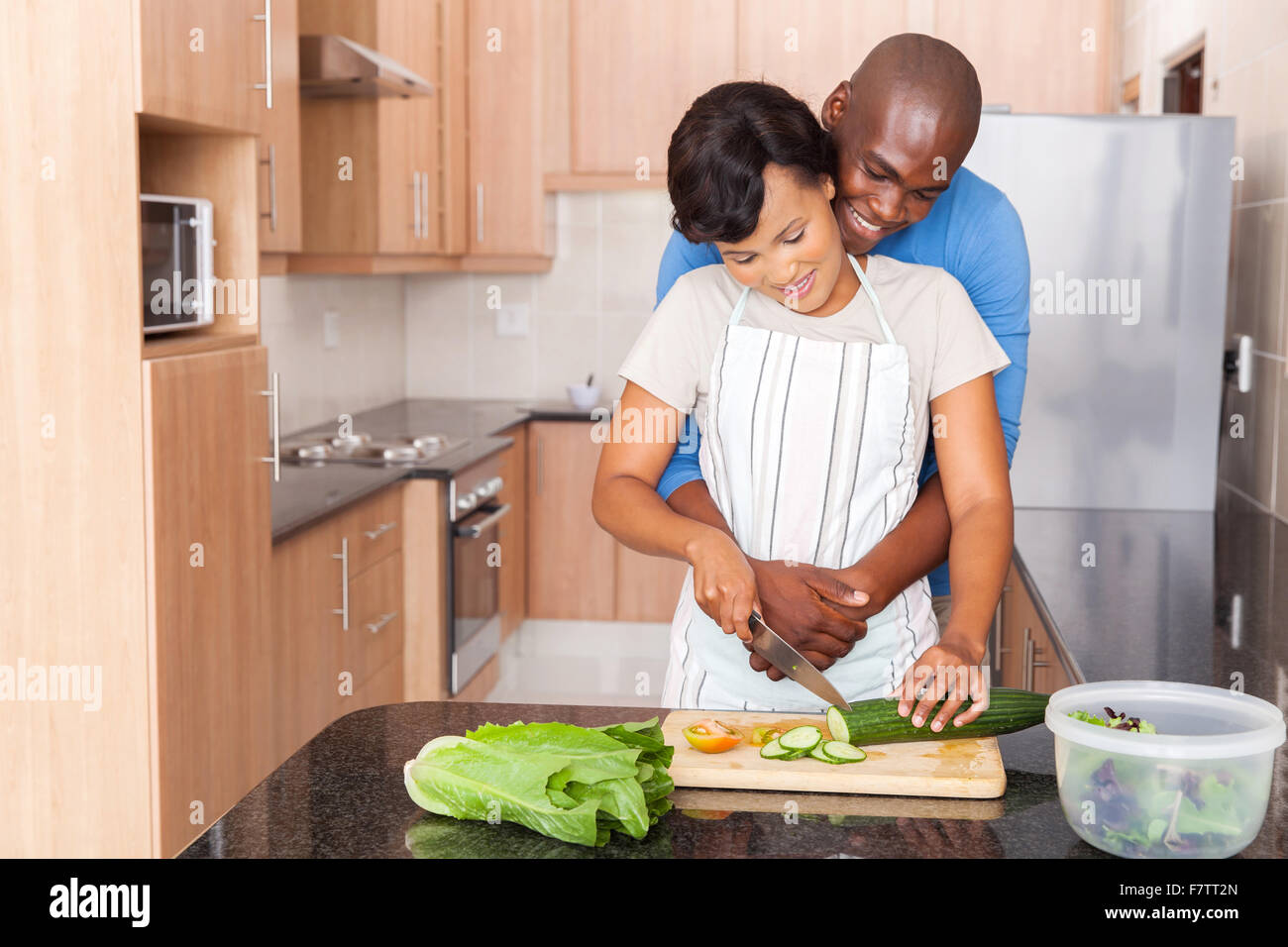 young African couple cooking in kitchen Stock Photo - Alamy
