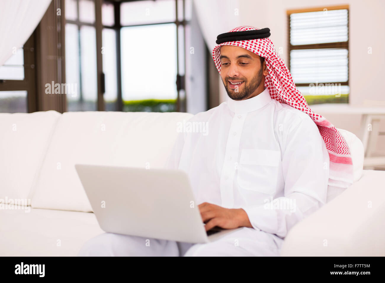 Saudi man using laptop hi-res stock photography and images - Alamy
