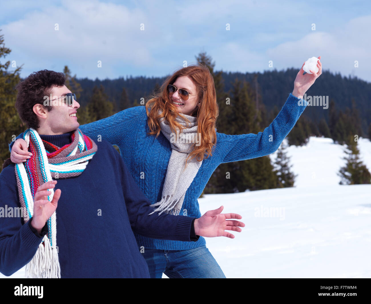 romantic winter scene, happy young couple having fun on fresh show on ...