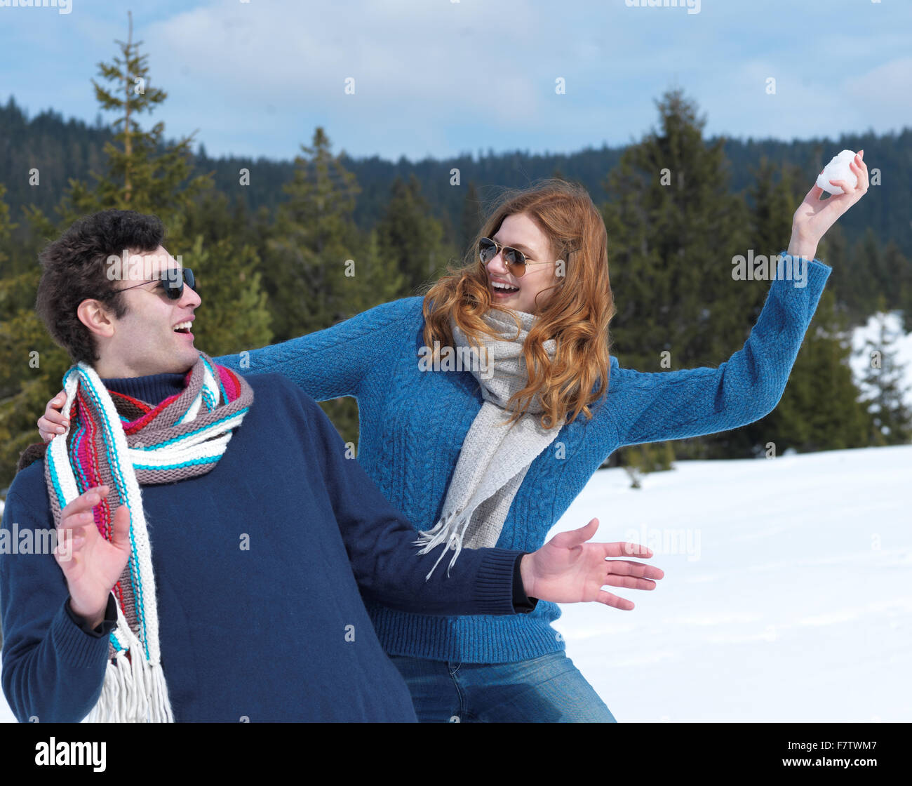 romantic winter scene, happy young couple having fun on fresh show on ...