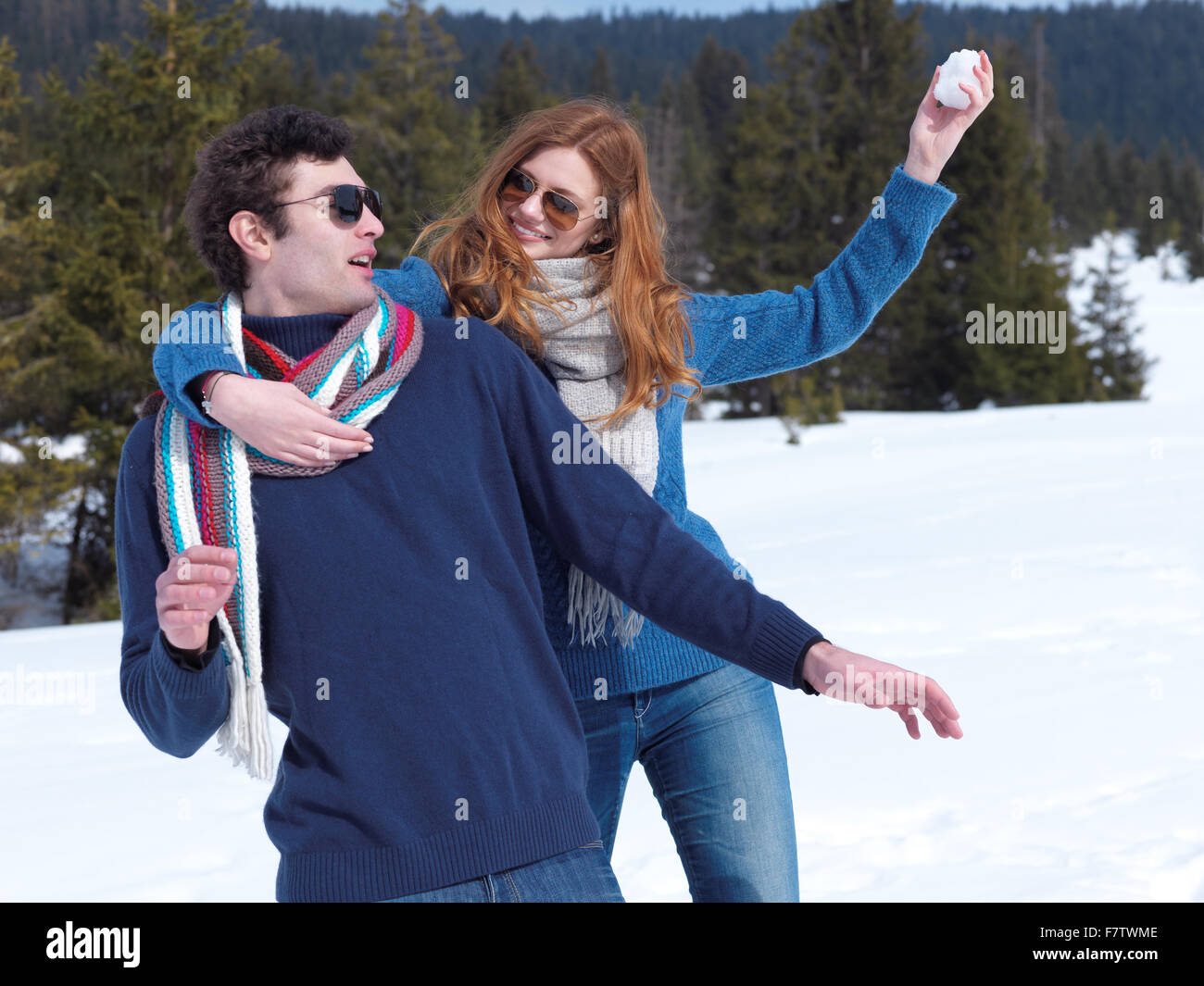 romantic winter scene, happy young couple having fun on fresh show on ...