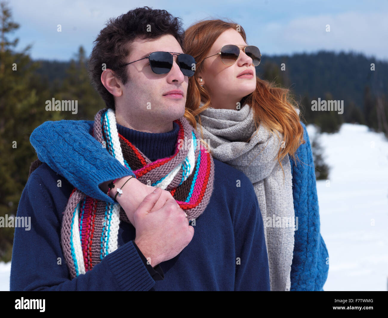 romantic winter scene, happy young couple having fun on fresh show on ...