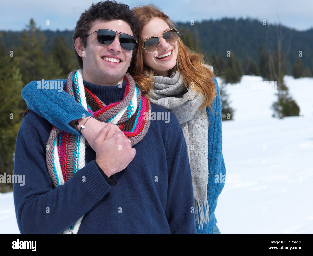 romantic winter scene, happy young couple having fun on fresh show on ...