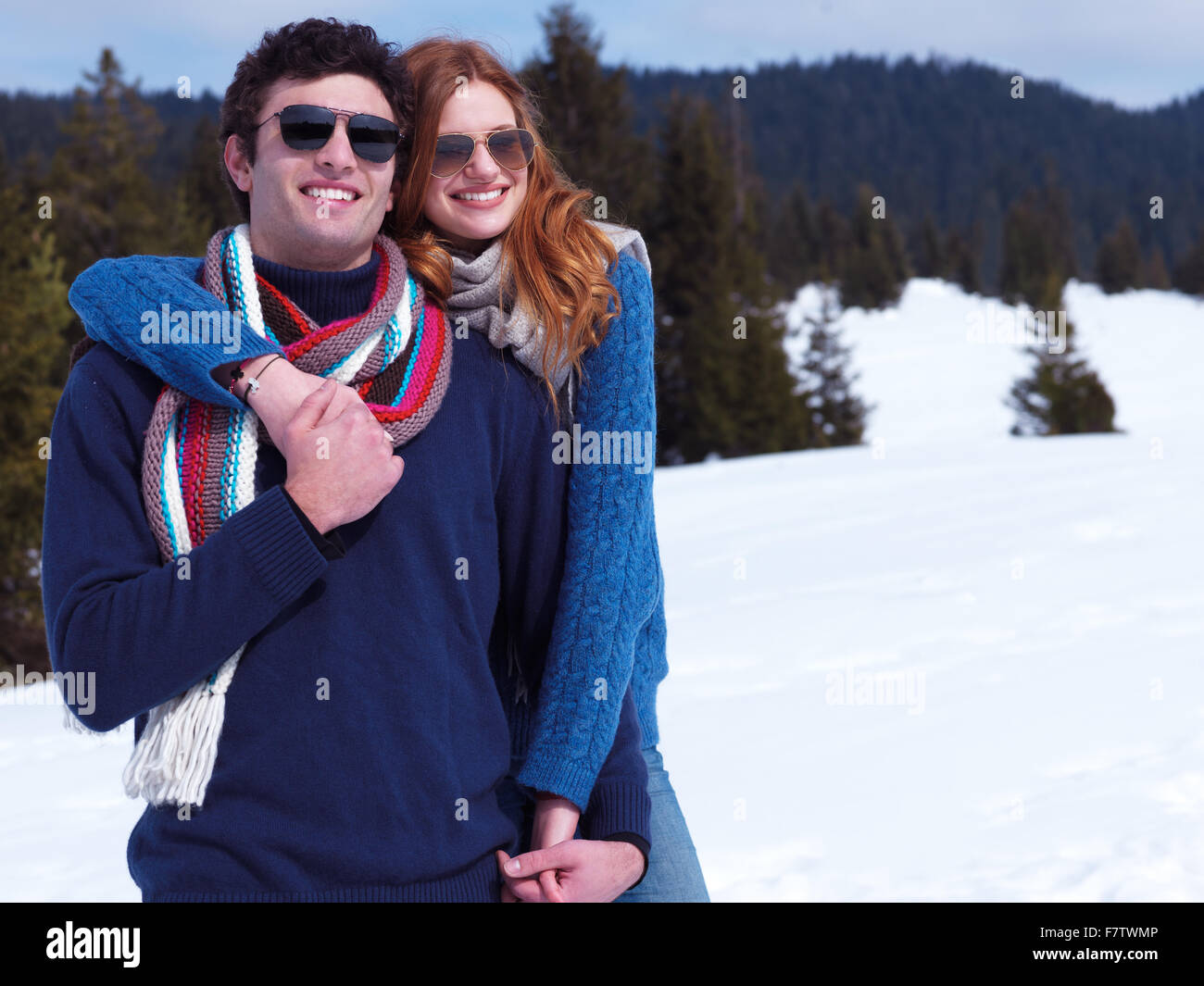 romantic winter scene, happy young couple having fun on fresh show on ...