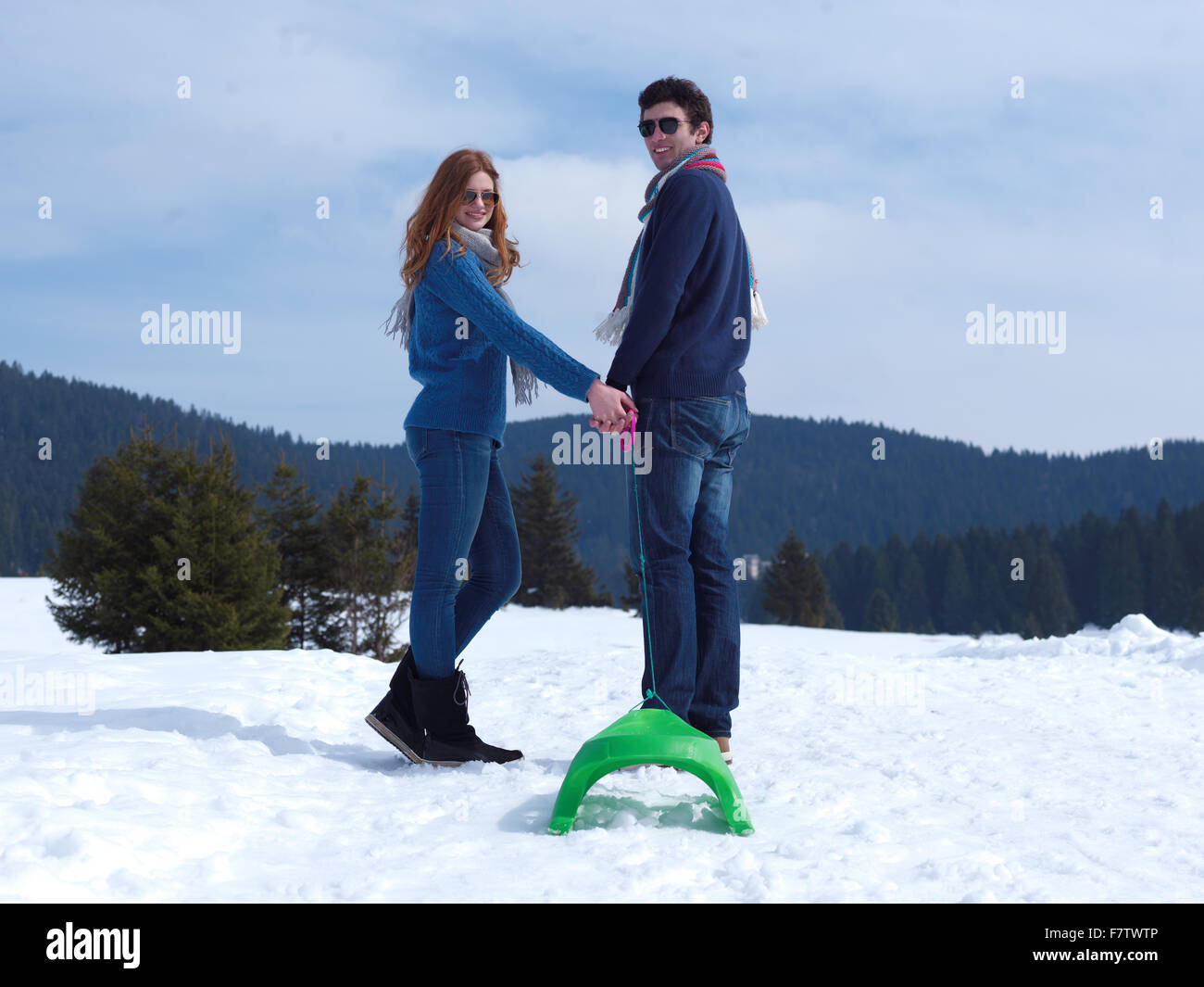 romantic winter scene, happy young couple having fun on fresh show on ...