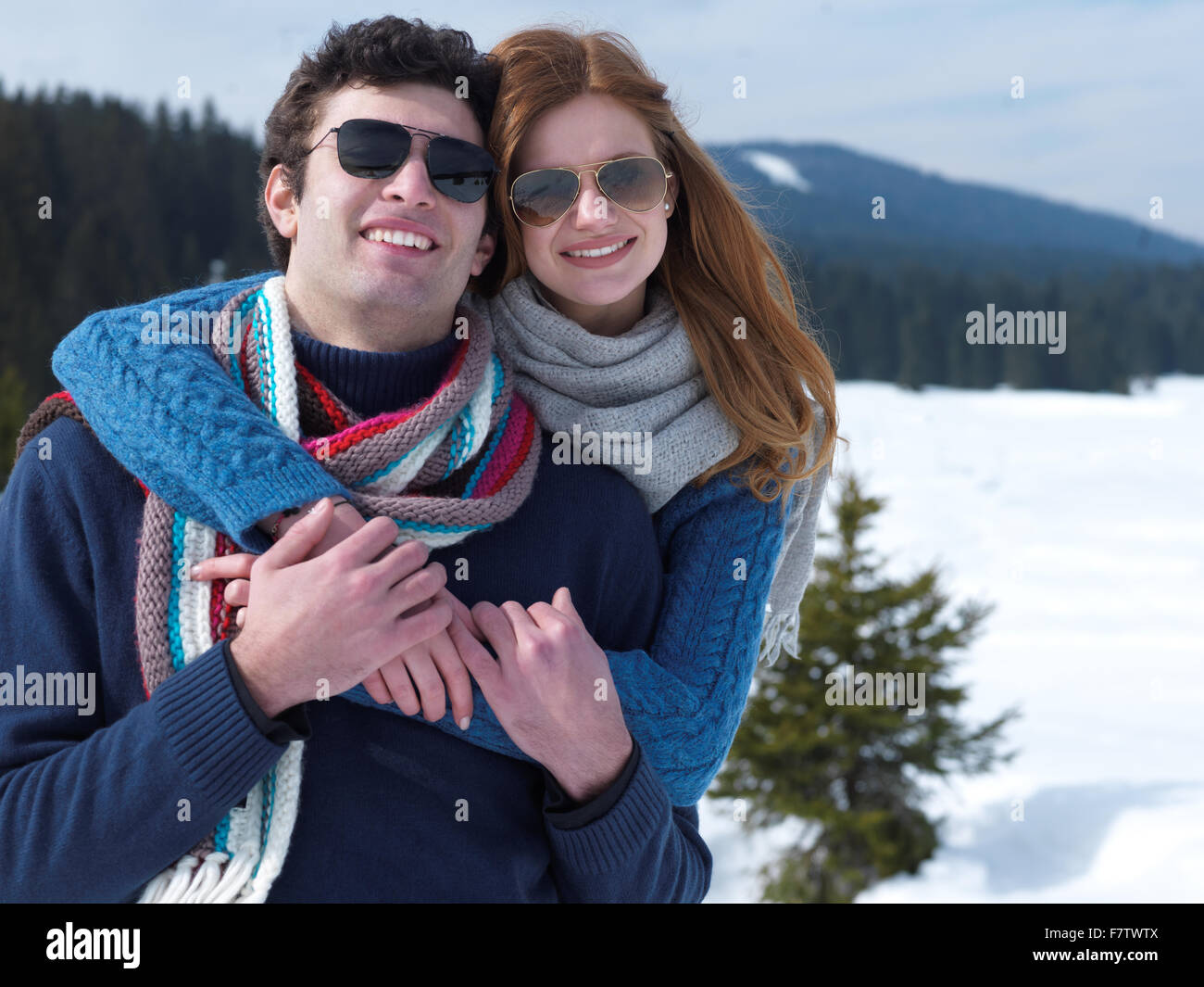 romantic winter scene, happy young couple having fun on fresh show on ...