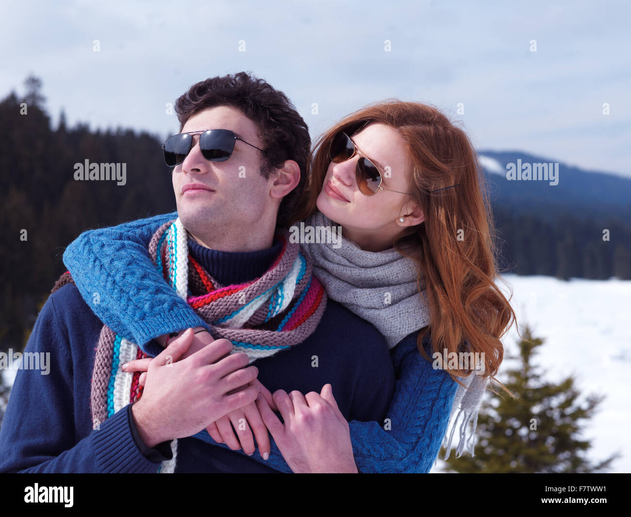 romantic winter scene, happy young couple having fun on fresh show on ...