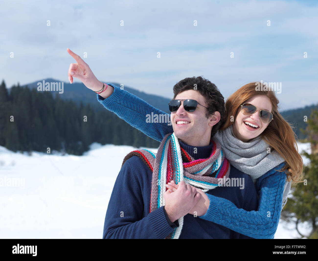 romantic winter scene, happy young couple having fun on fresh show on ...