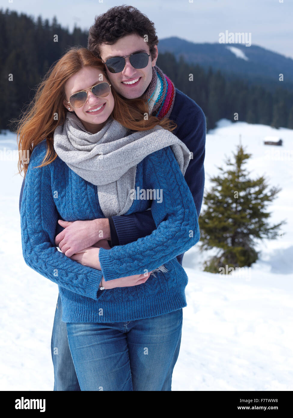 romantic winter scene, happy young couple having fun on fresh show on ...