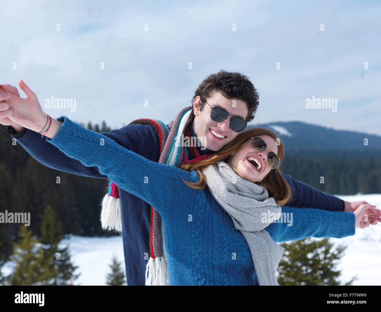 romantic winter scene, happy young couple having fun on fresh show on ...