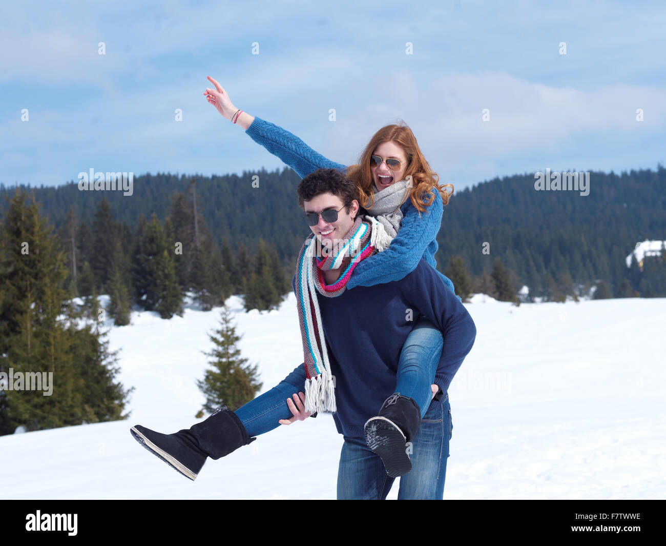 romantic winter scene, happy young couple having fun on fresh show on ...