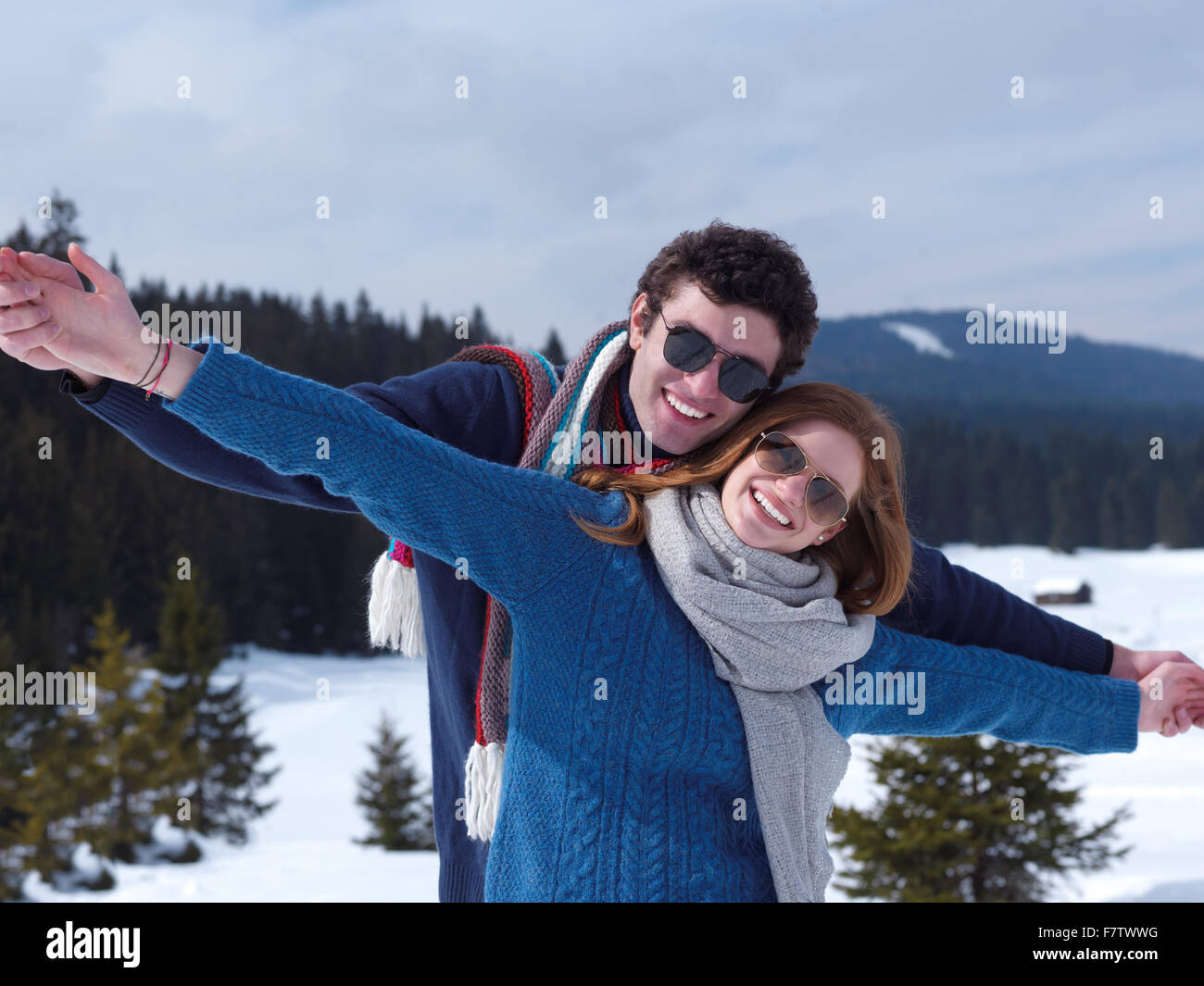 romantic winter scene, happy young couple having fun on fresh show on ...