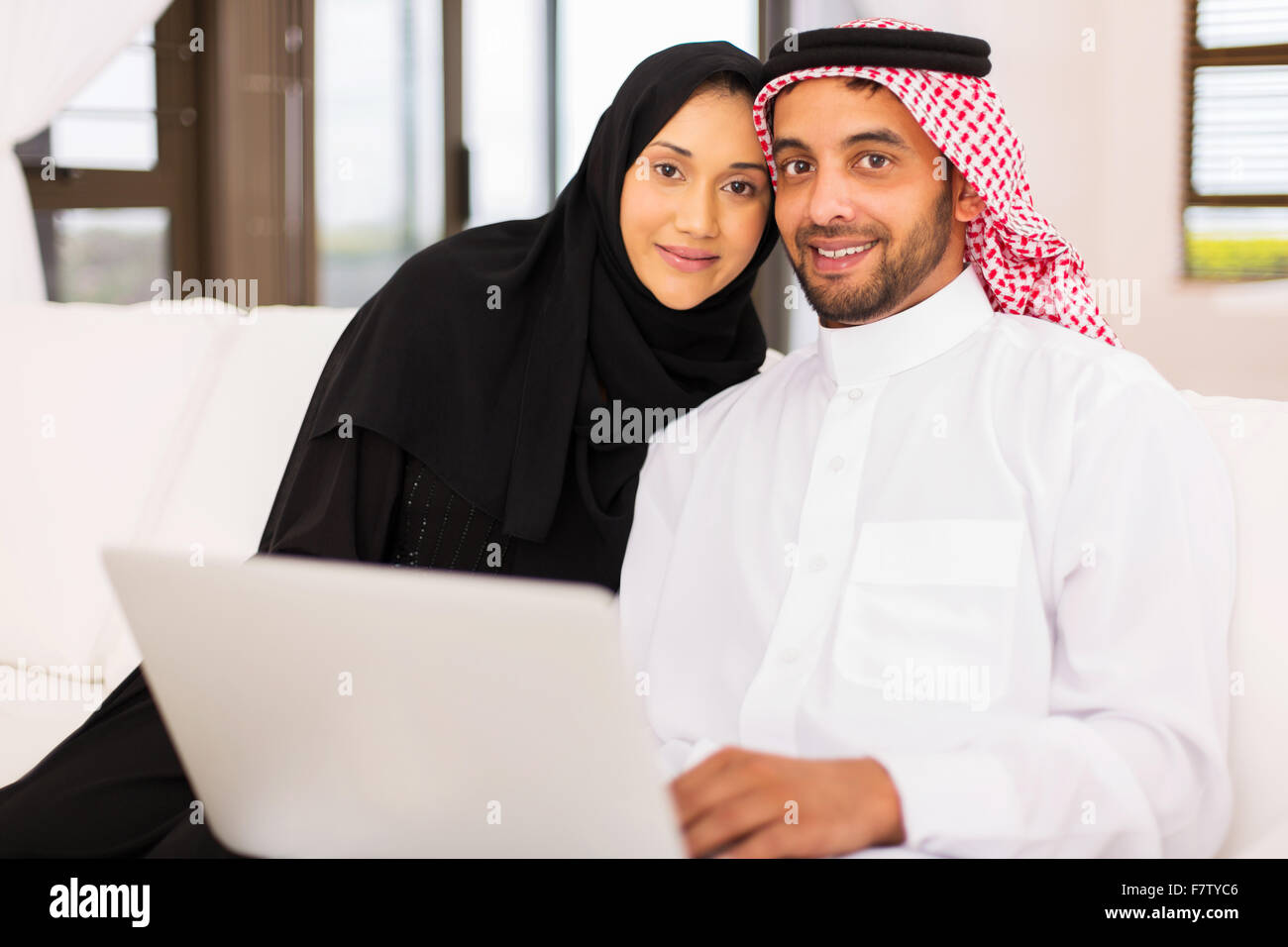 modern Muslim couple using laptop computer at home Stock Photo - Alamy
