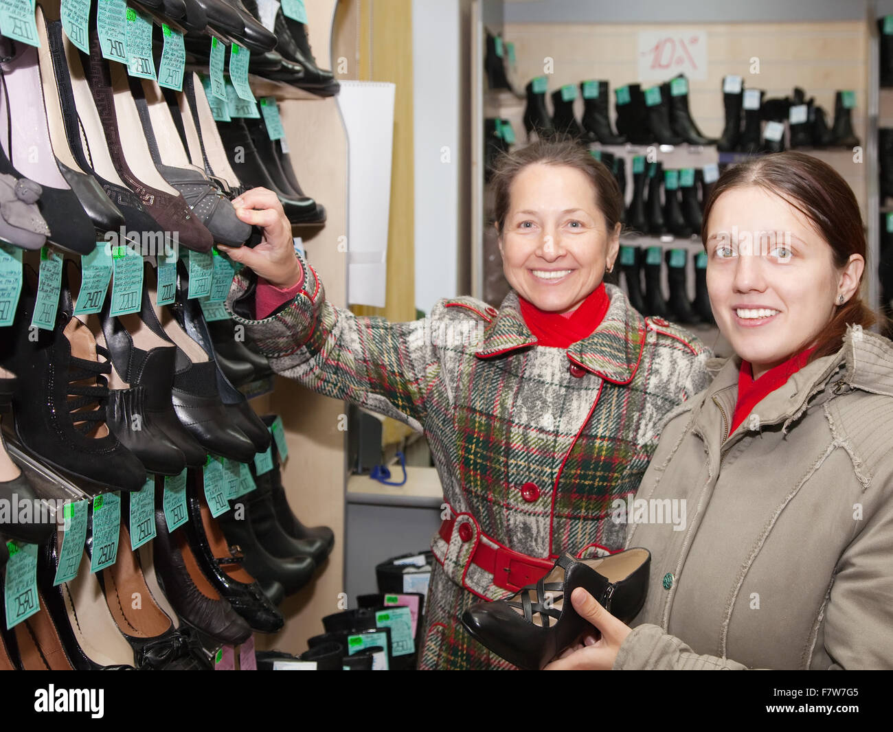 Two women shopping at fashion shoe store Stock Photo - Alamy