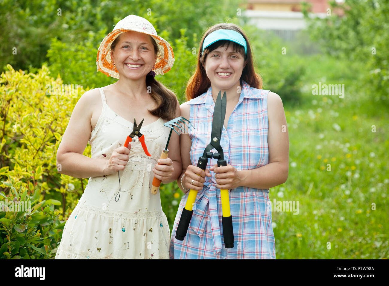 Female gardeners working with garden tools at yard Stock Photo - Alamy