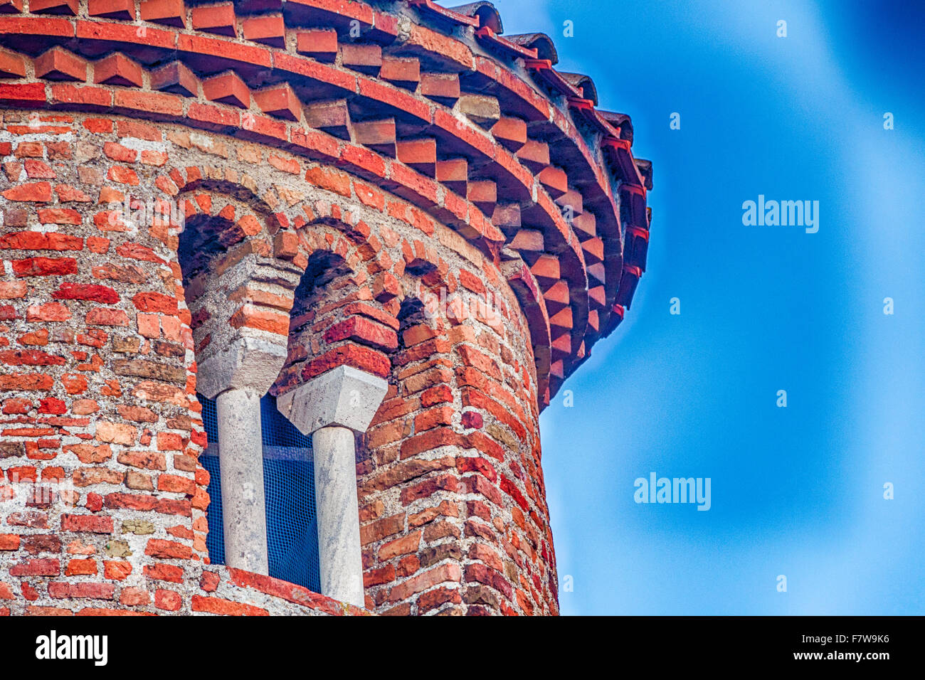 mullioned window of cylindrical bell tower of the medieval Catholic ...
