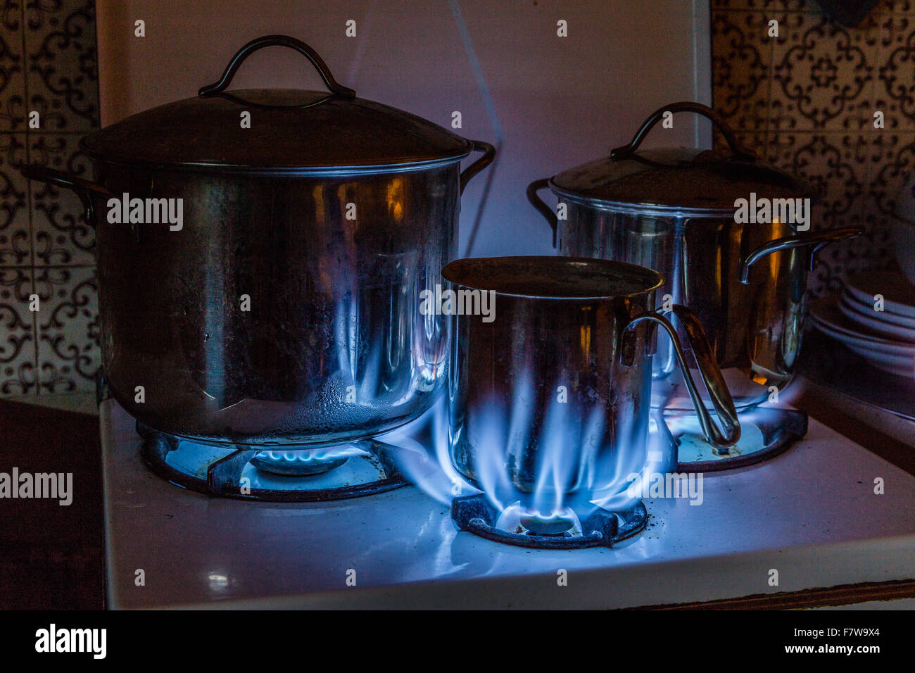 old encrusted gas stove with three pots on fires Stock Photo - Alamy