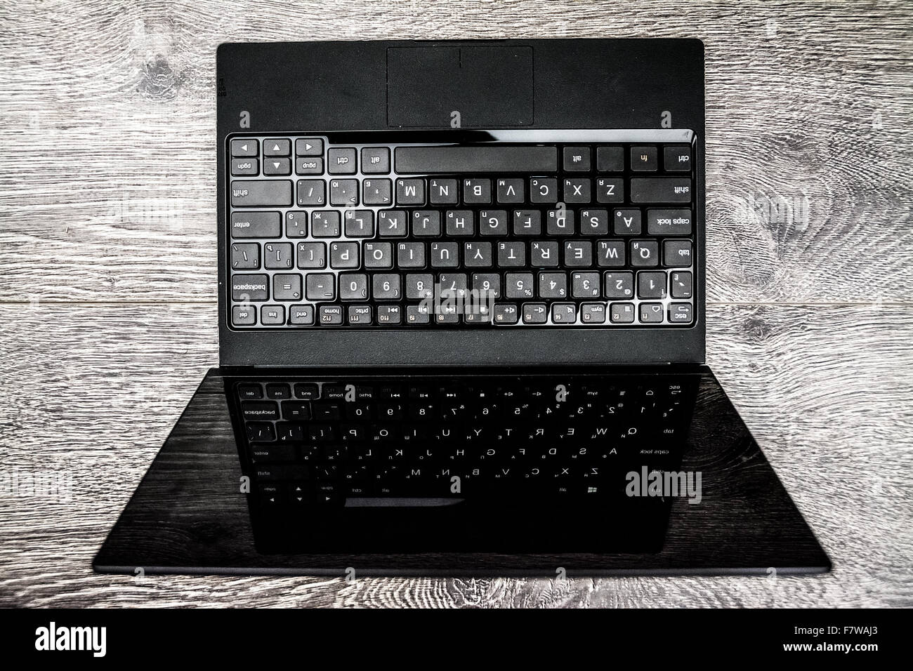 black laptop on wood Stock Photo - Alamy