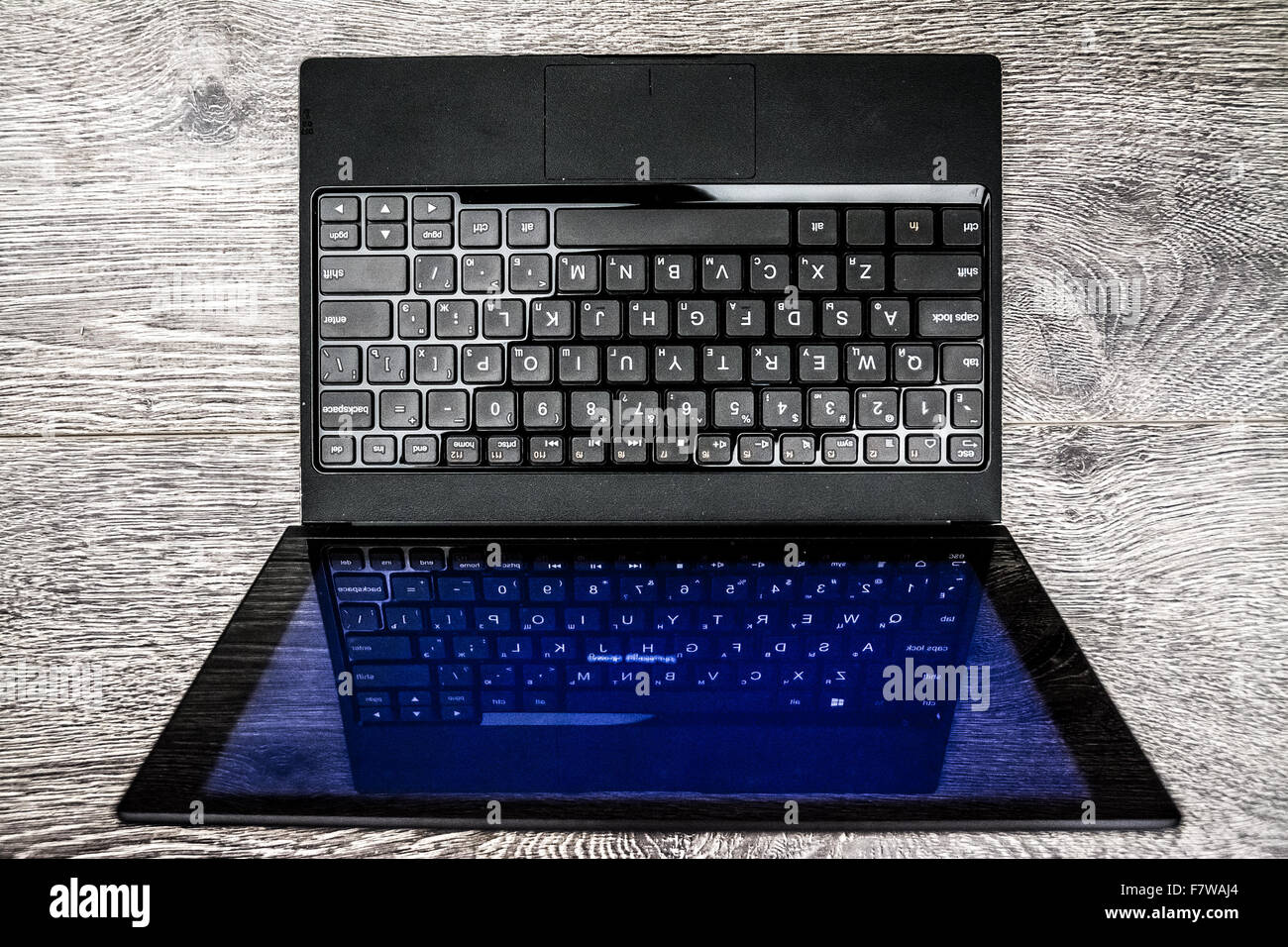 black laptop on wood Stock Photo - Alamy