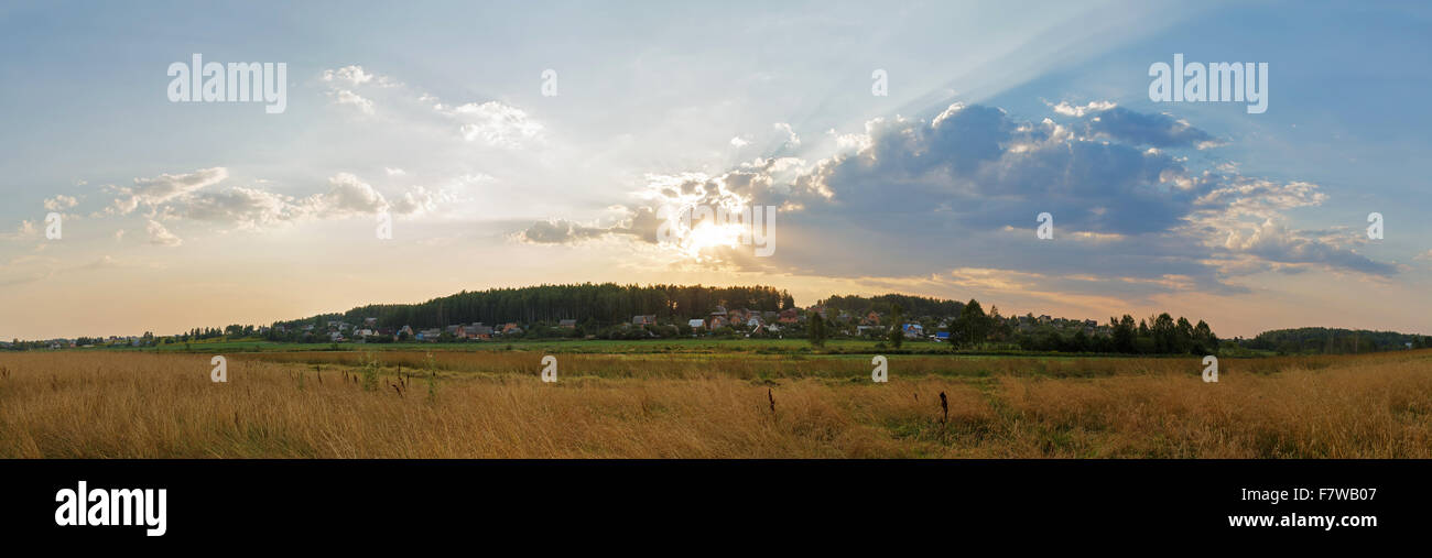 A picturesque sunset in the countryside. Panoramic rural landscape ...