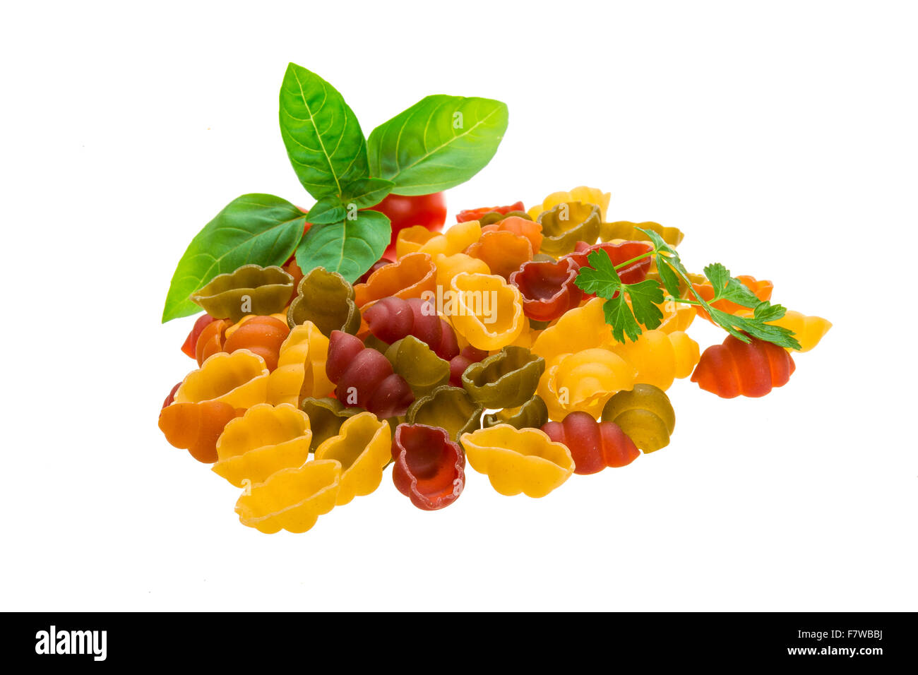Raw macaroni variet color with basil Stock Photo - Alamy