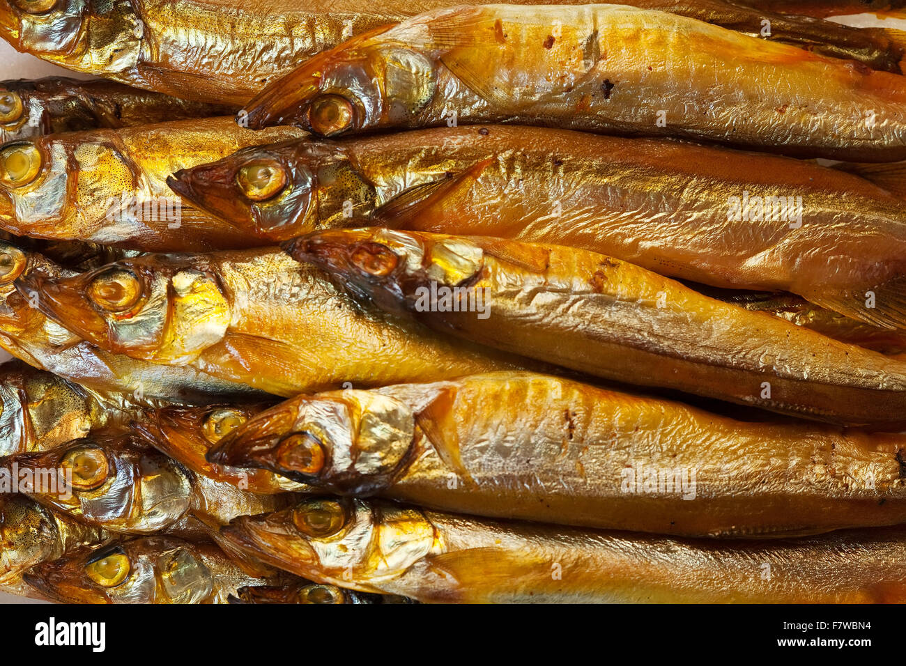 background of golden smoke-dried fish close up Stock Photo - Alamy