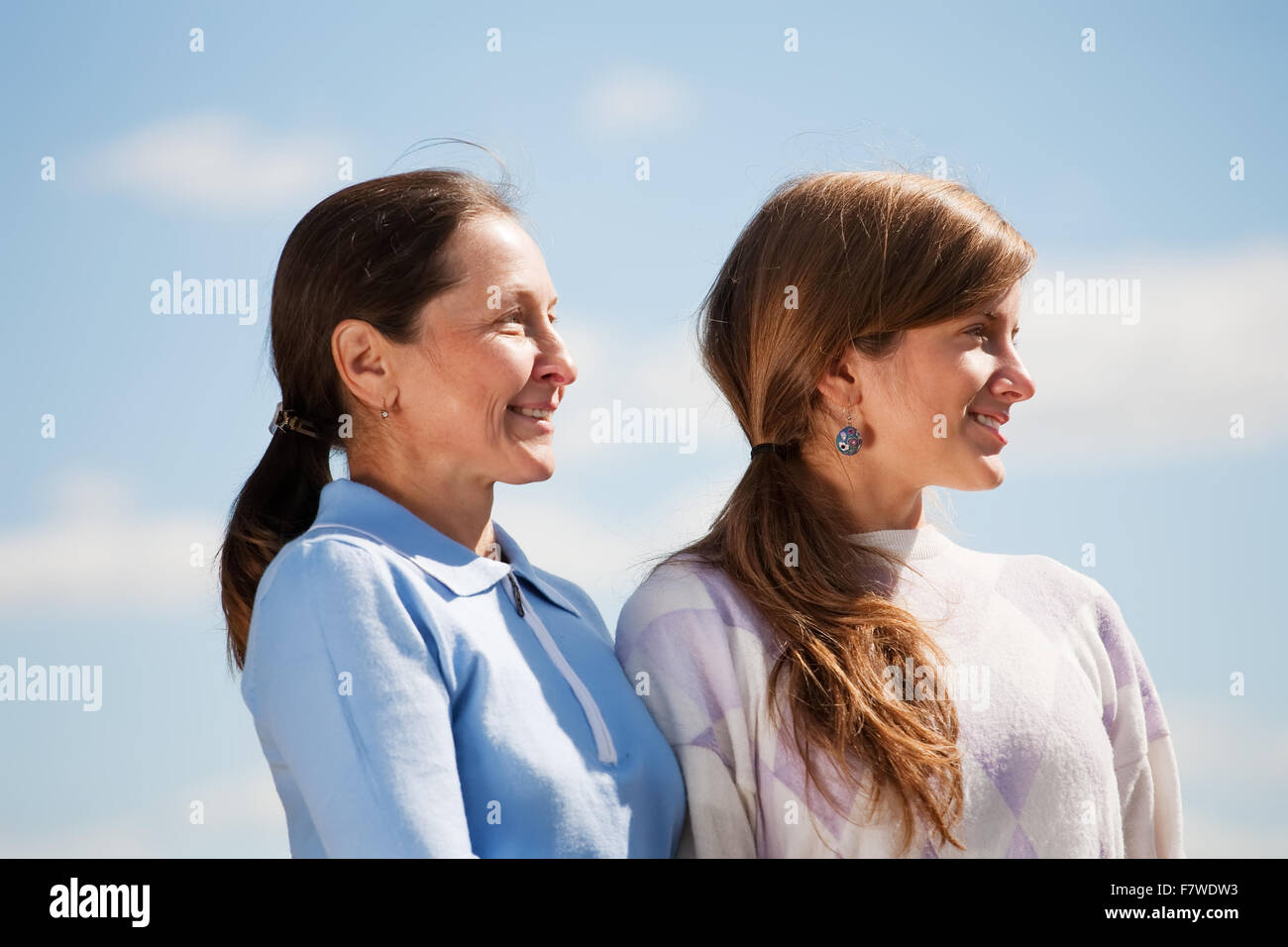 Portrait of mother with teenager daughter against sky Stock Photo - Alamy