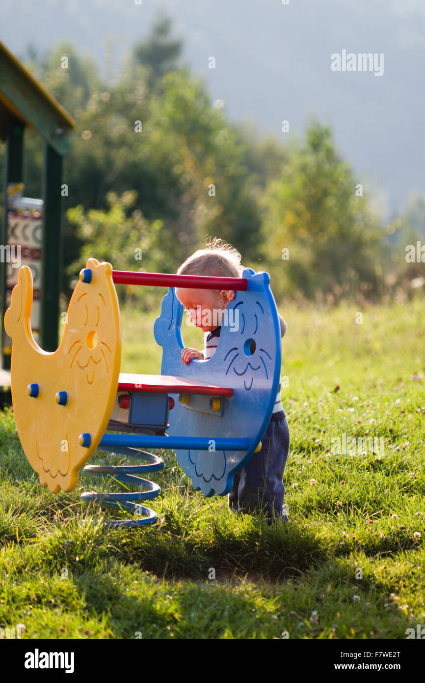 Baby plays on the playground Stock Photo - Alamy