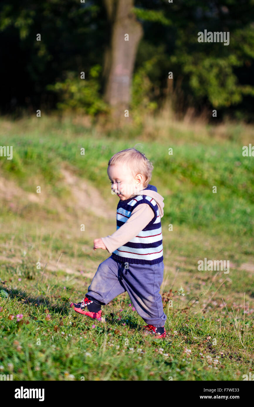 First steps of baby on nature background Stock Photo - Alamy