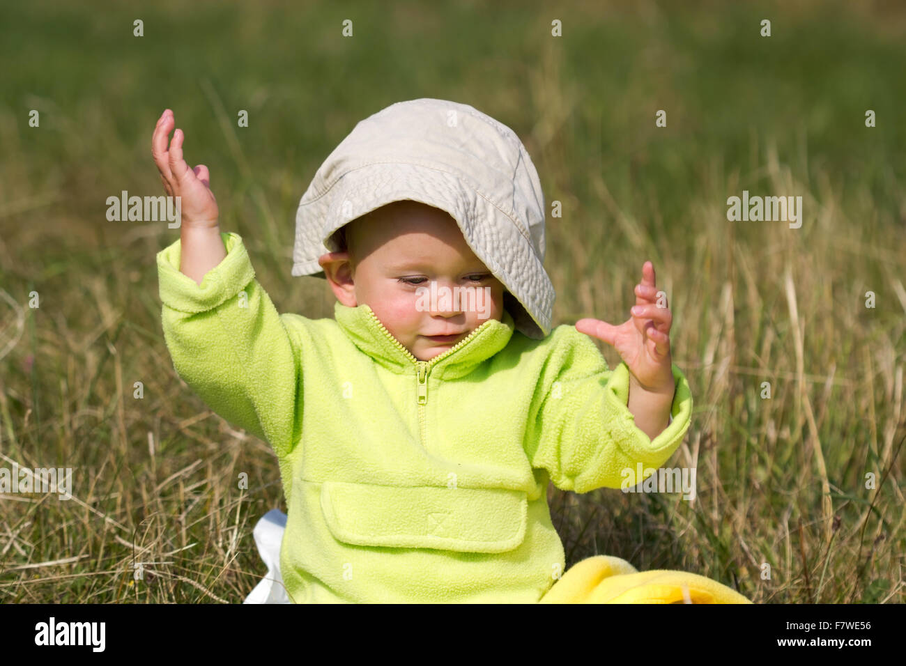 Child playing with hat on picnic Stock Photo - Alamy