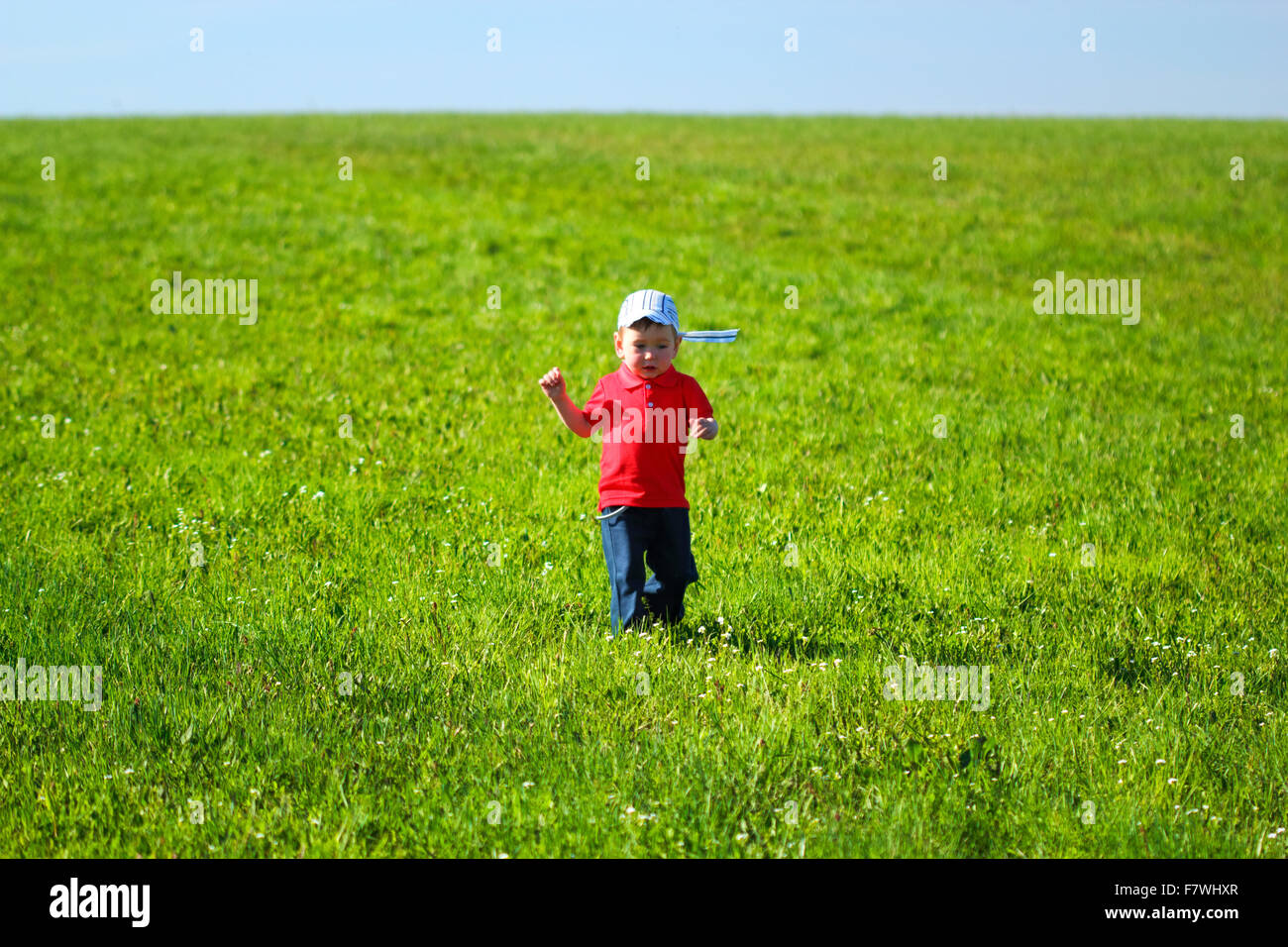 Portrait of Running baby at grass background Stock Photo - Alamy