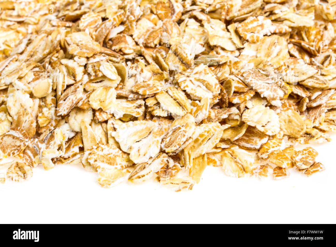 Heap of dry rolled oats isolated on white background Stock Photo - Alamy