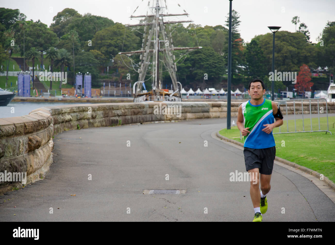 A man running through the Royal Botanic Gardens next to Sydney Harbour ...