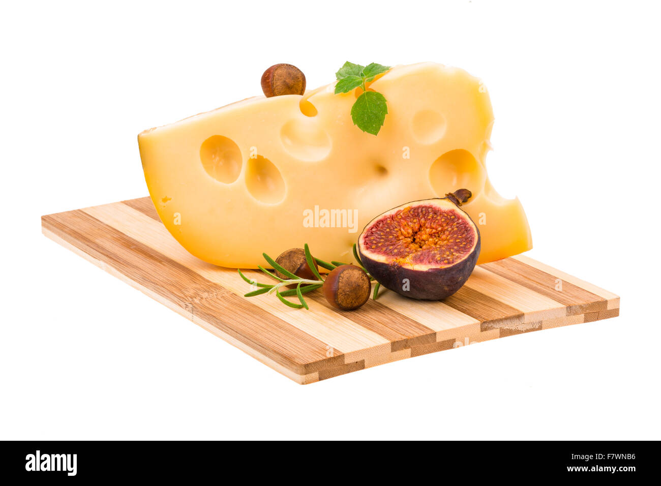 Maasdam cheese with fig and herbs Stock Photo - Alamy