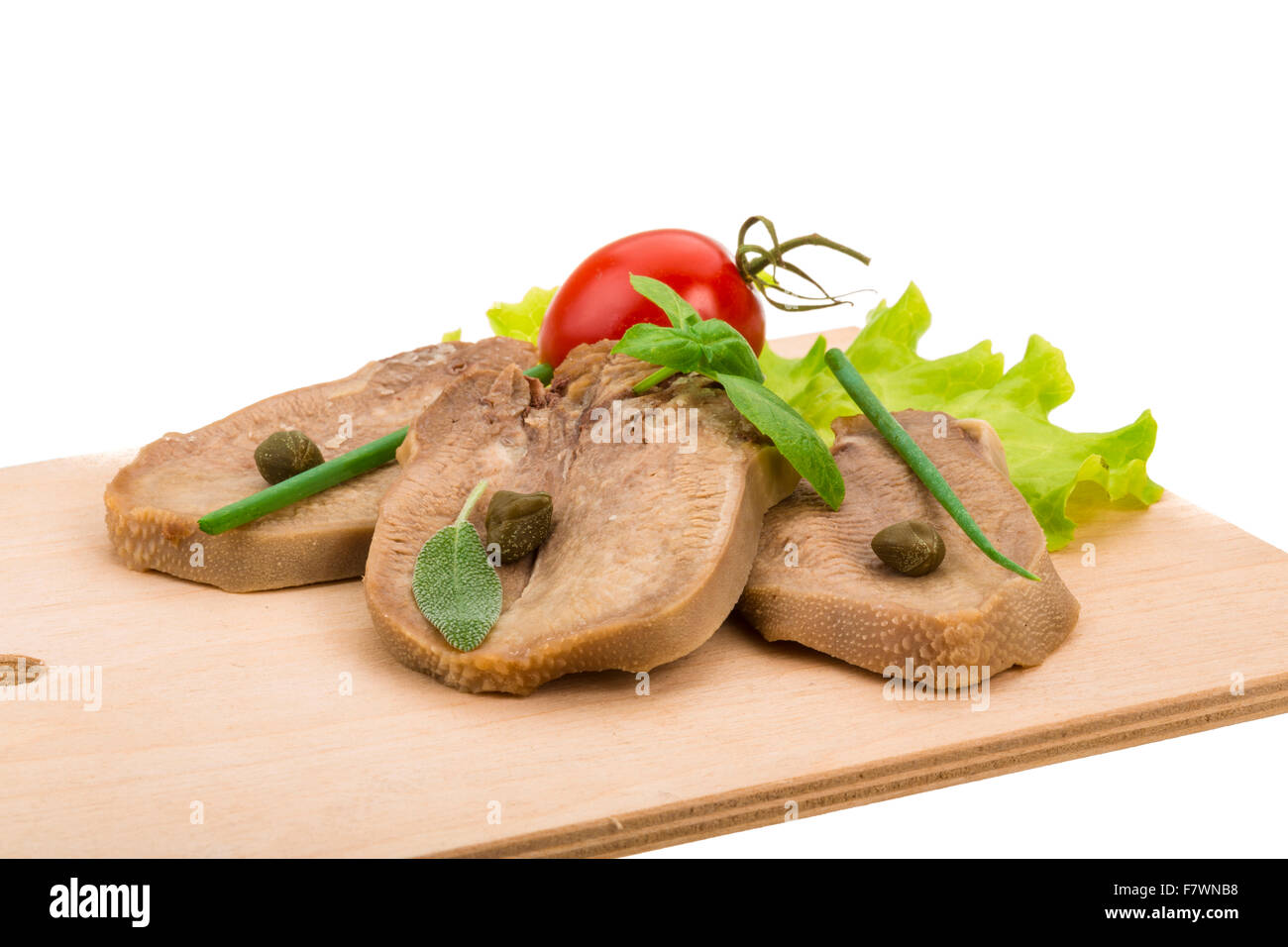 Beef tongue with herbs isolated Stock Photo - Alamy