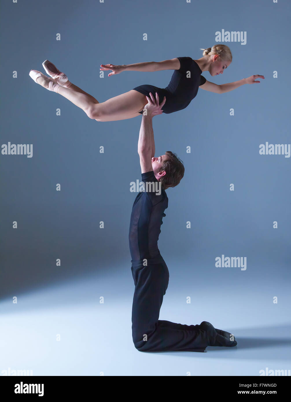two young modern ballet dancers on blue studio background Stock Photo ...