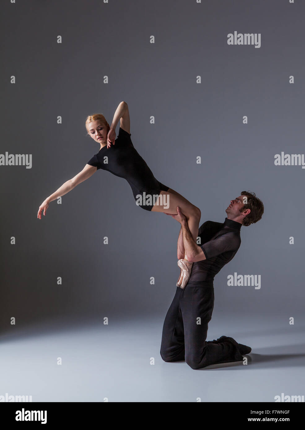 two young modern ballet dancers on gray studio background Stock Photo ...