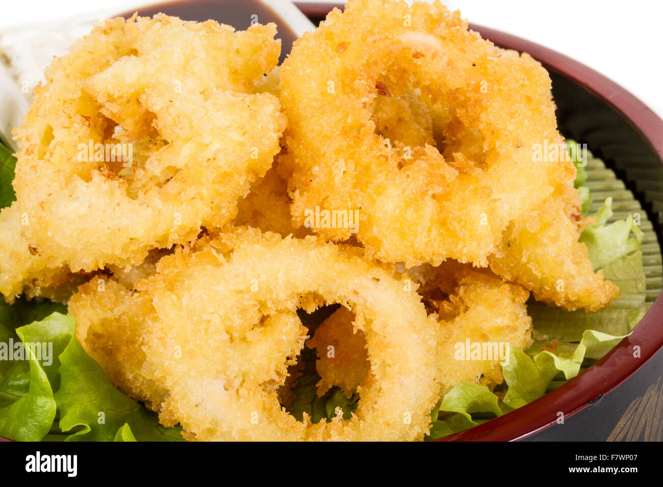 Deep batter fried squid rings calamari with green salad Stock Photo - Alamy