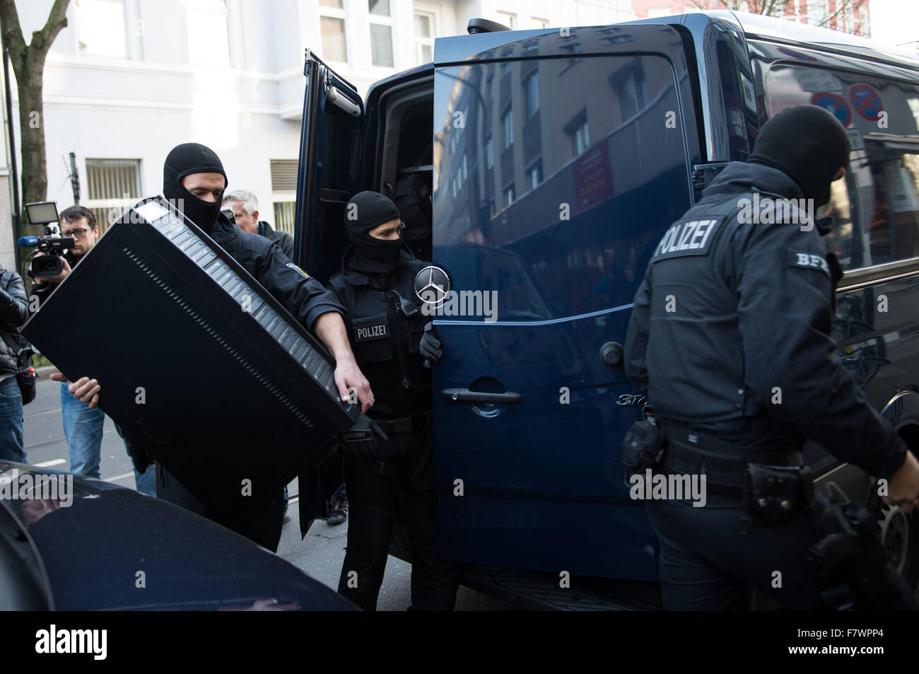 Duesseldorf, Germany. 03rd Dec, 2015. Masked police officers carry a ...