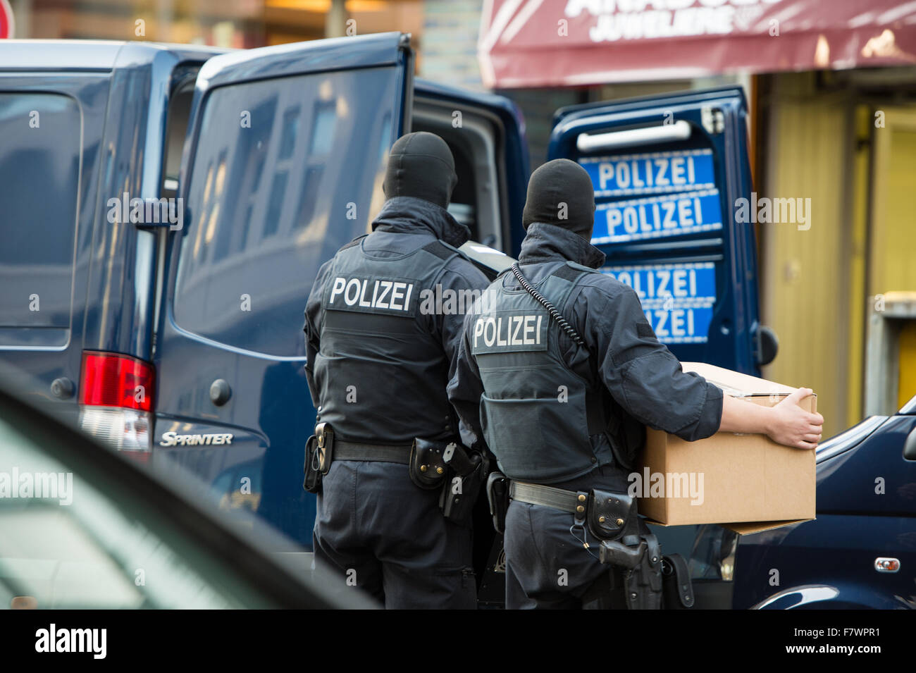 Duesseldorf, Germany. 03rd Dec, 2015. Masked police officers carry a ...