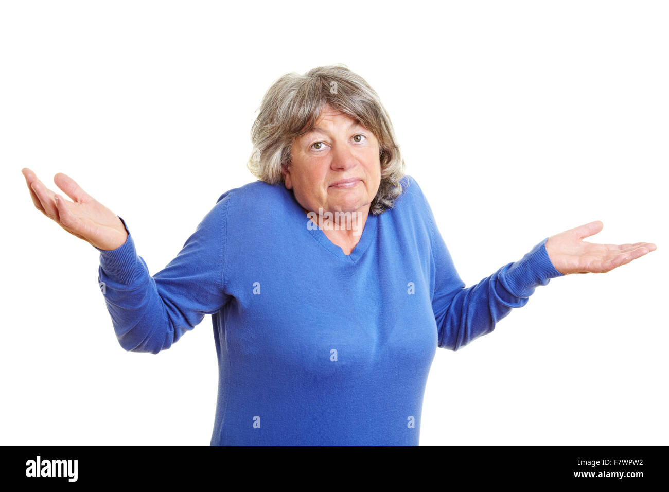 Clueless elderly woman shrugging with her shoulders Stock Photo - Alamy