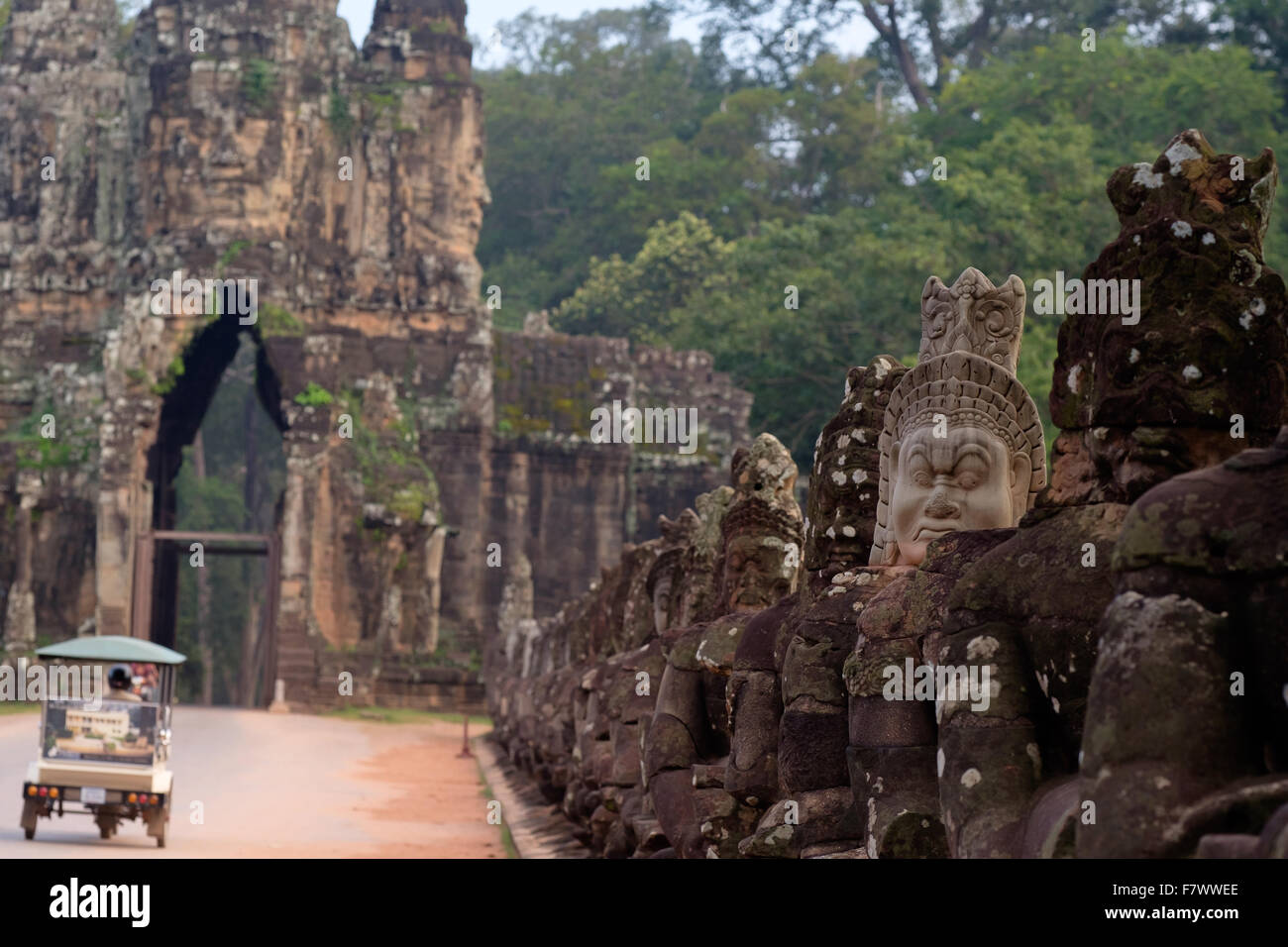 Stone carved faces on the bridge at the south gate of Angkor Thom ...