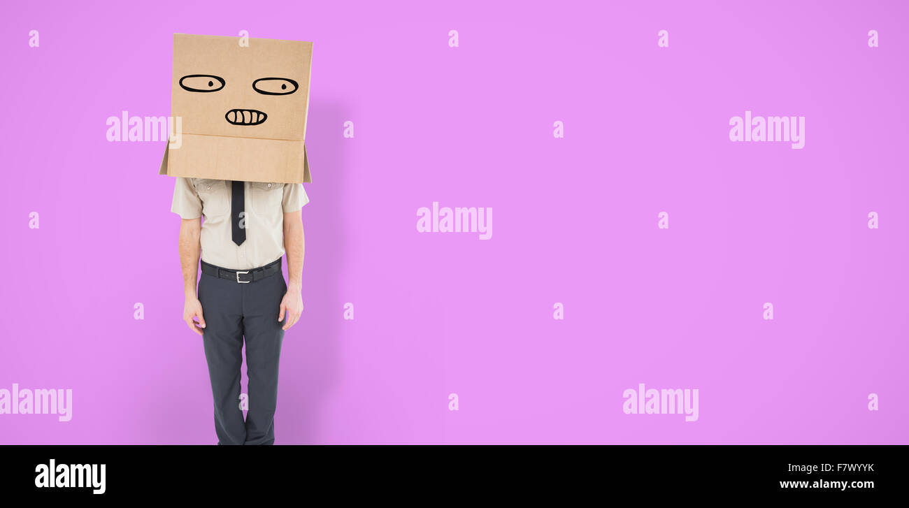 Composite image of businessman standing with box on head Stock Photo ...