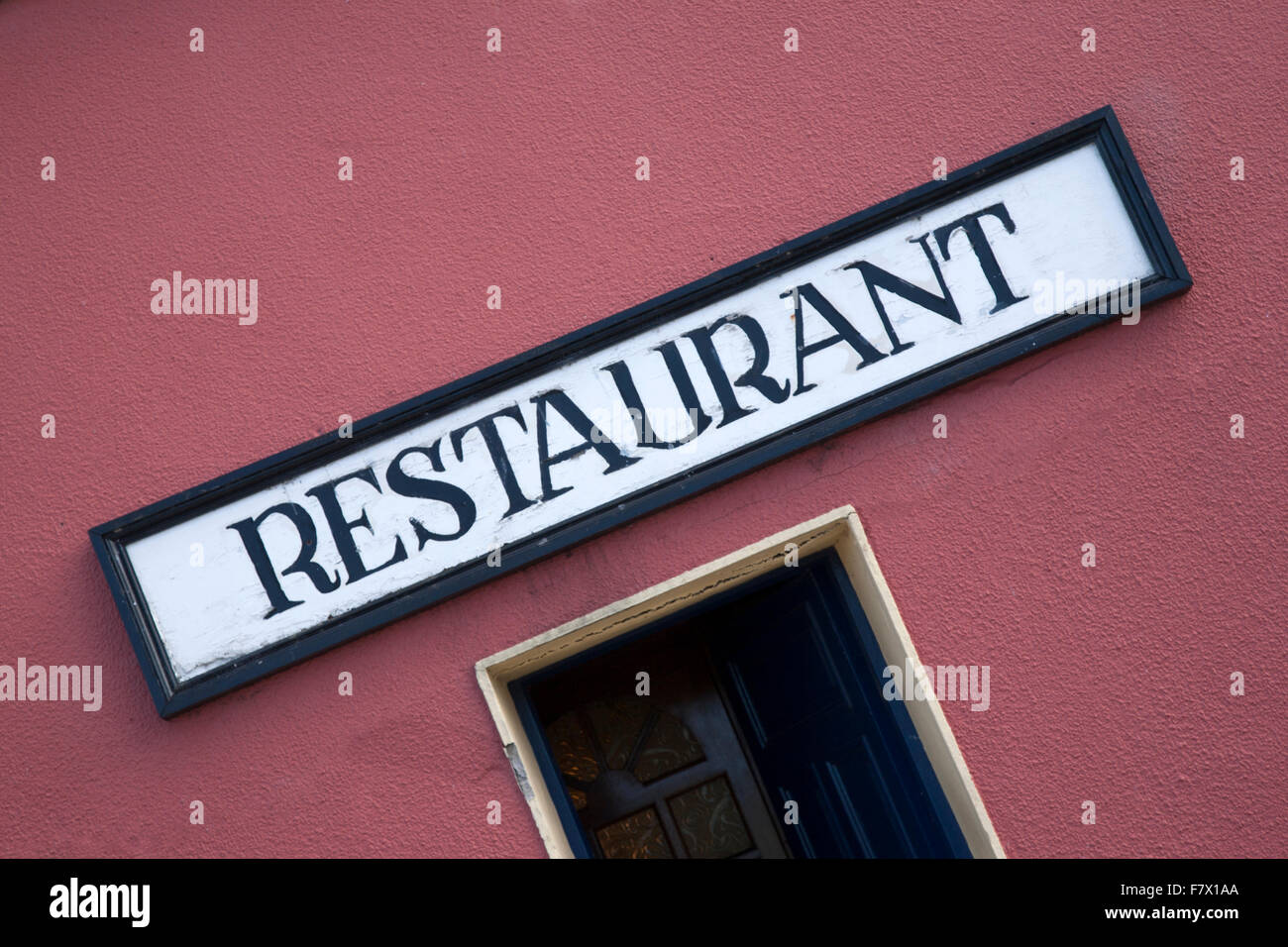 Restaurant Sign on Red Building Facade Stock Photo - Alamy