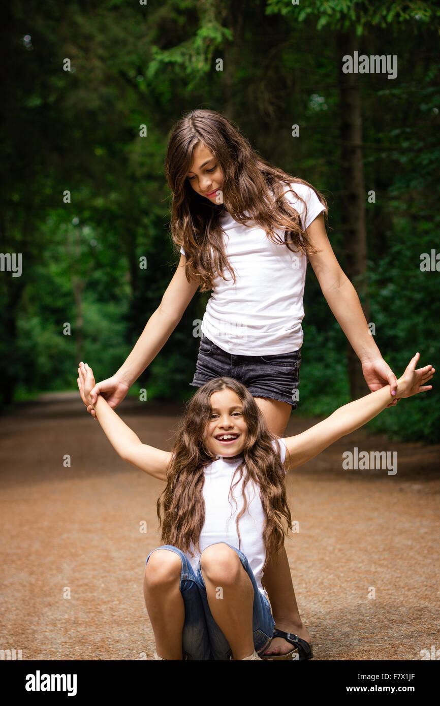 Two girls messing about outdoors Stock Photo - Alamy