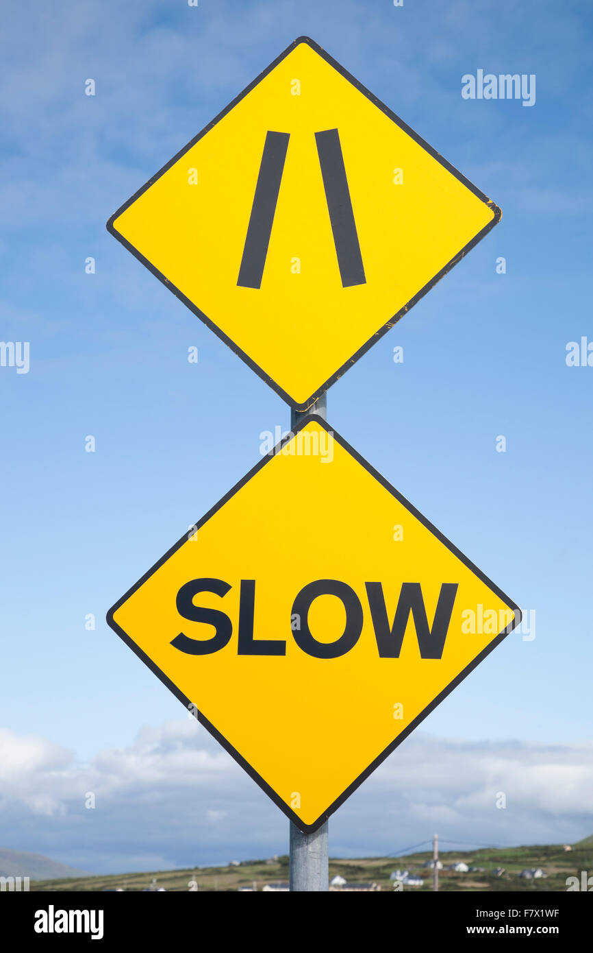 Yellow Slow Sign against Blue Sky Background Stock Photo - Alamy