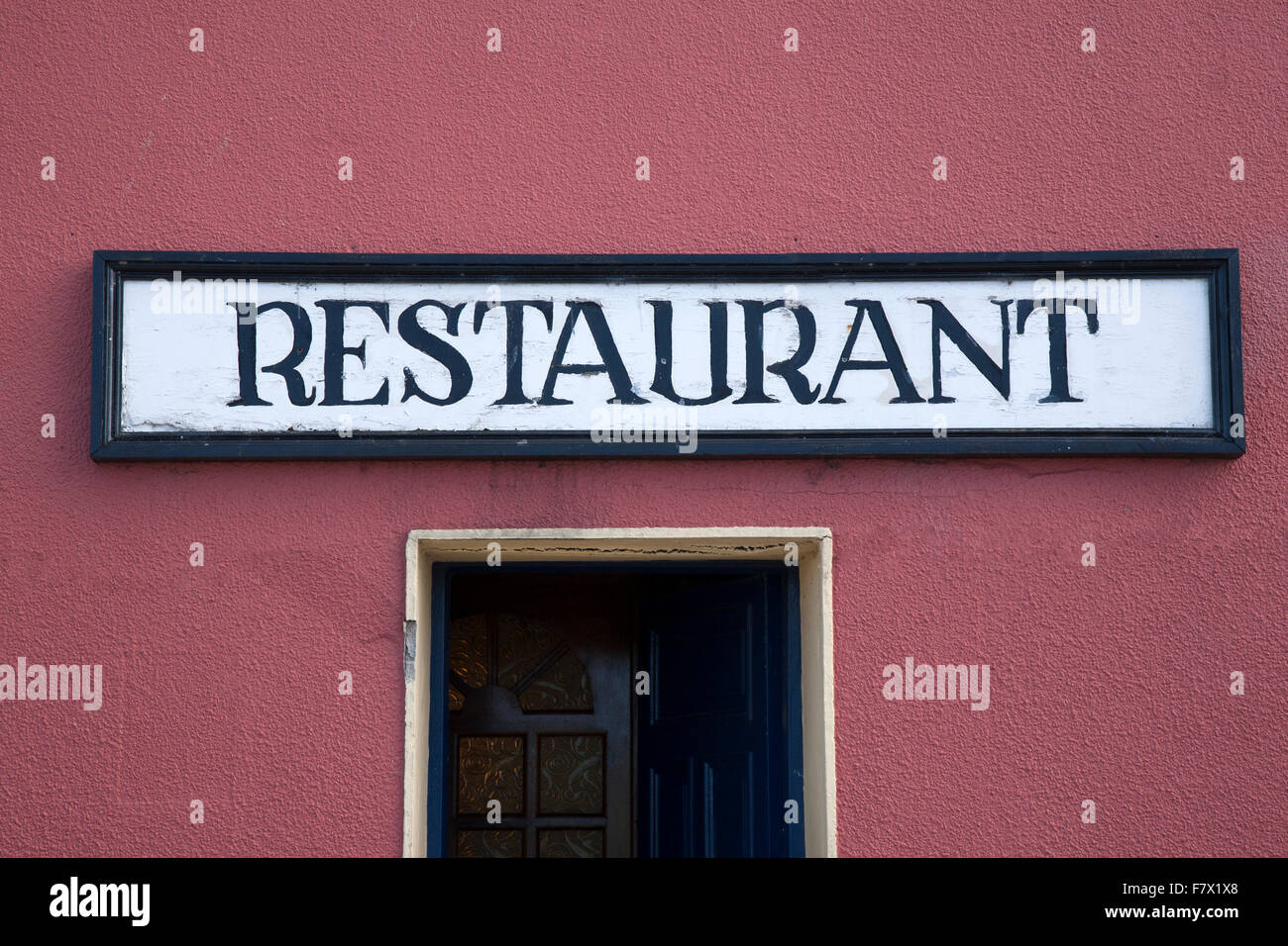 Restaurant Sign on Red Building Facade Stock Photo - Alamy