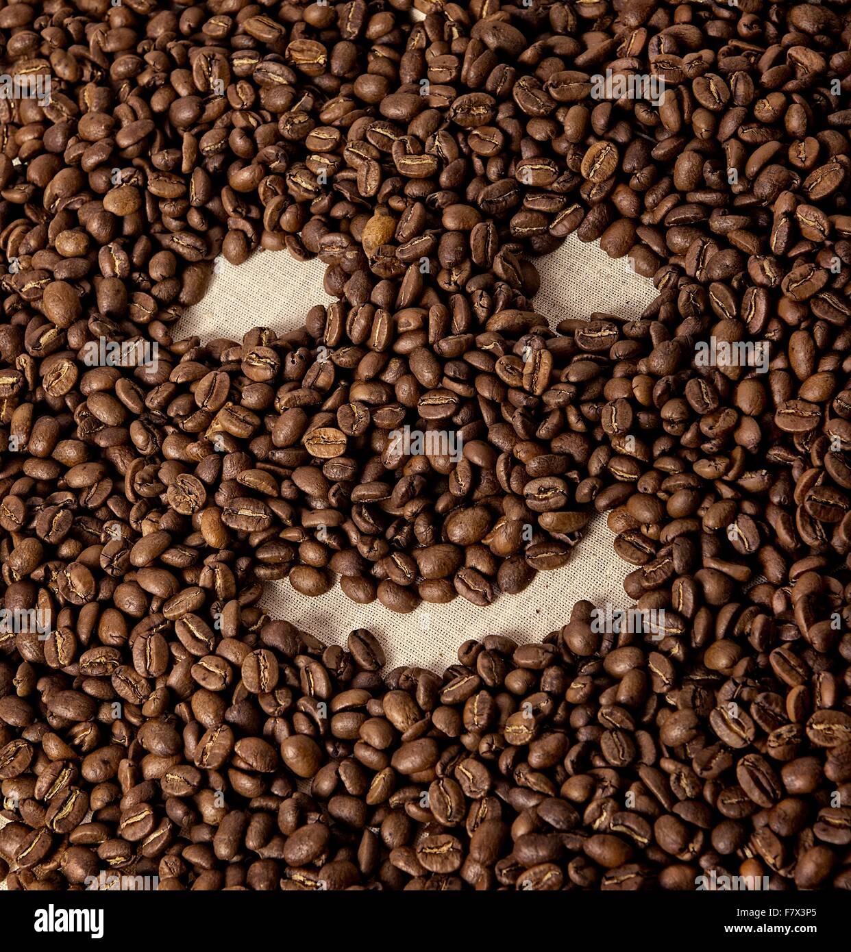 Conceptual smiley face made from coffee beans Stock Photo - Alamy